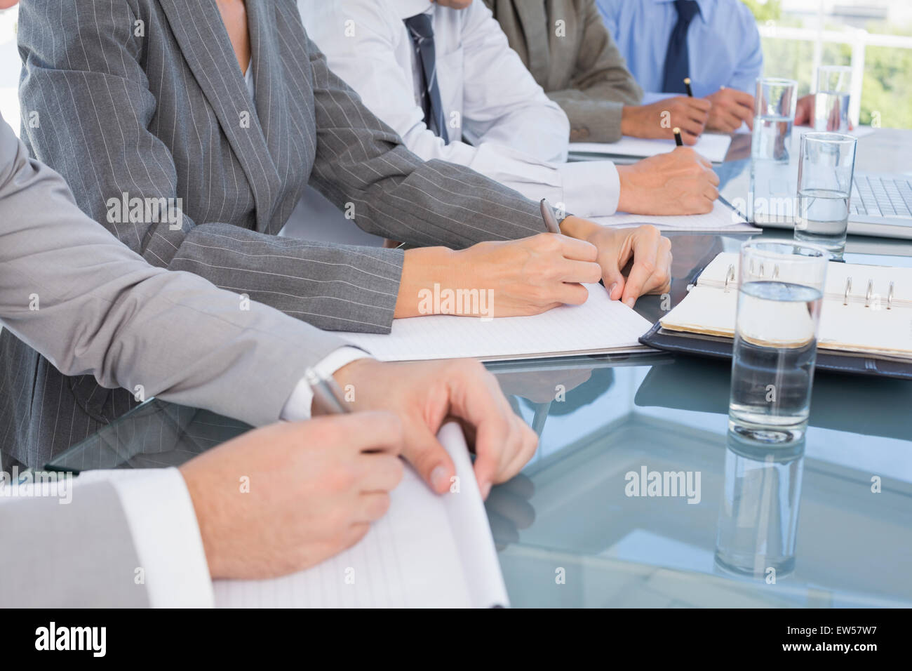 Business team taking notes during conference Stock Photo - Alamy