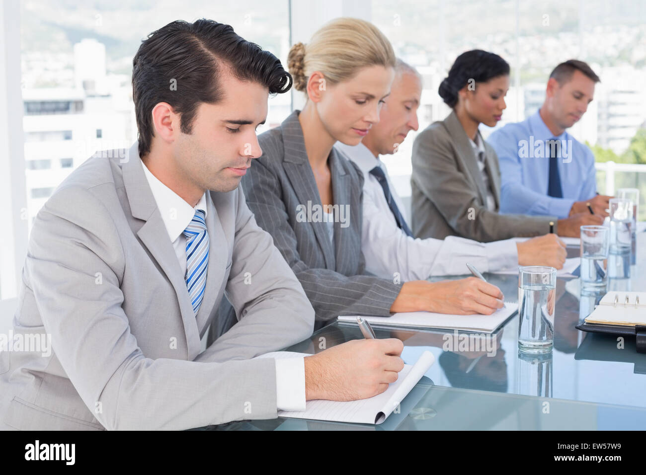 Business team taking notes during conference Stock Photo - Alamy