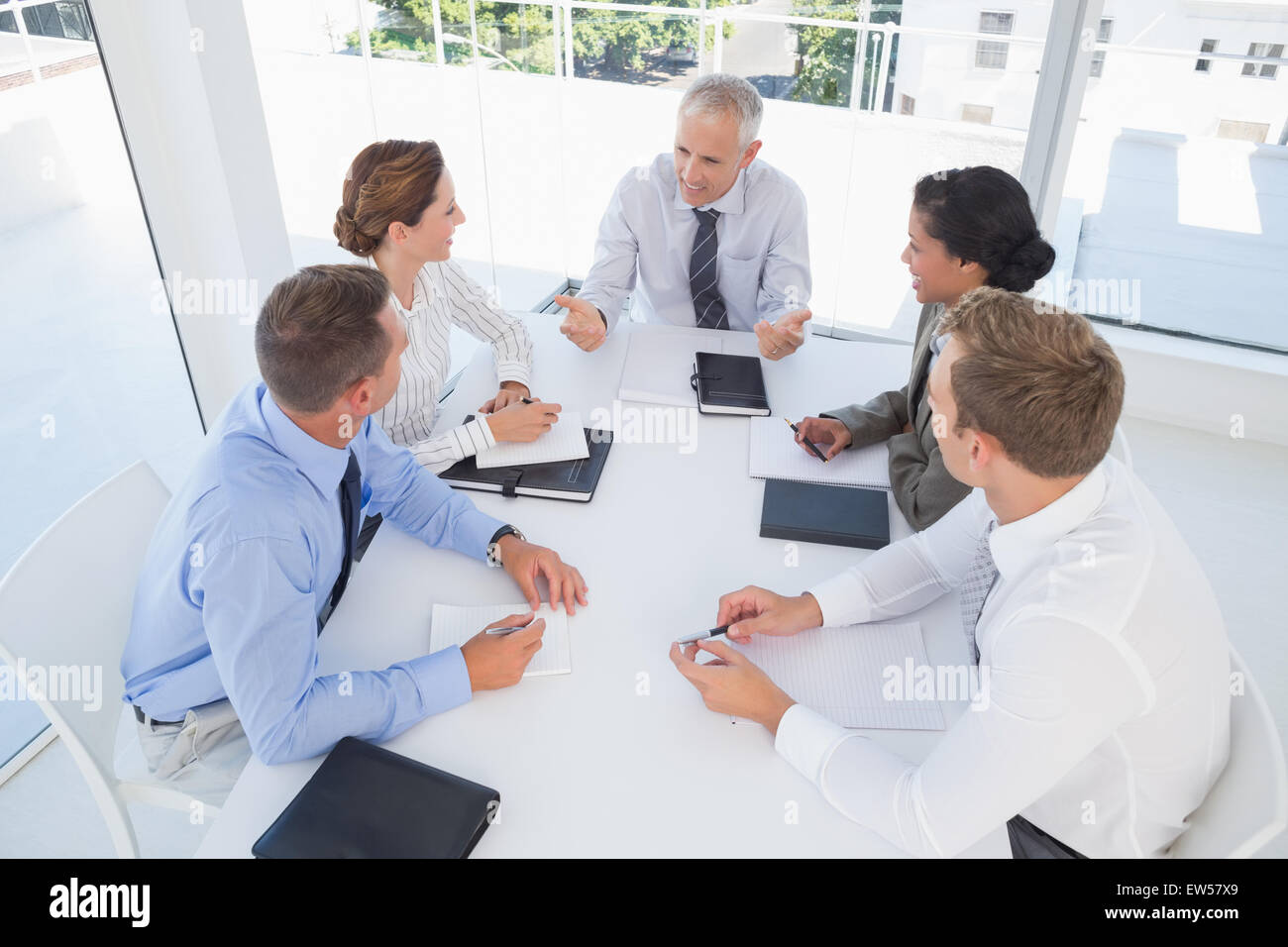 Business team sitting together around the table Stock Photo - Alamy