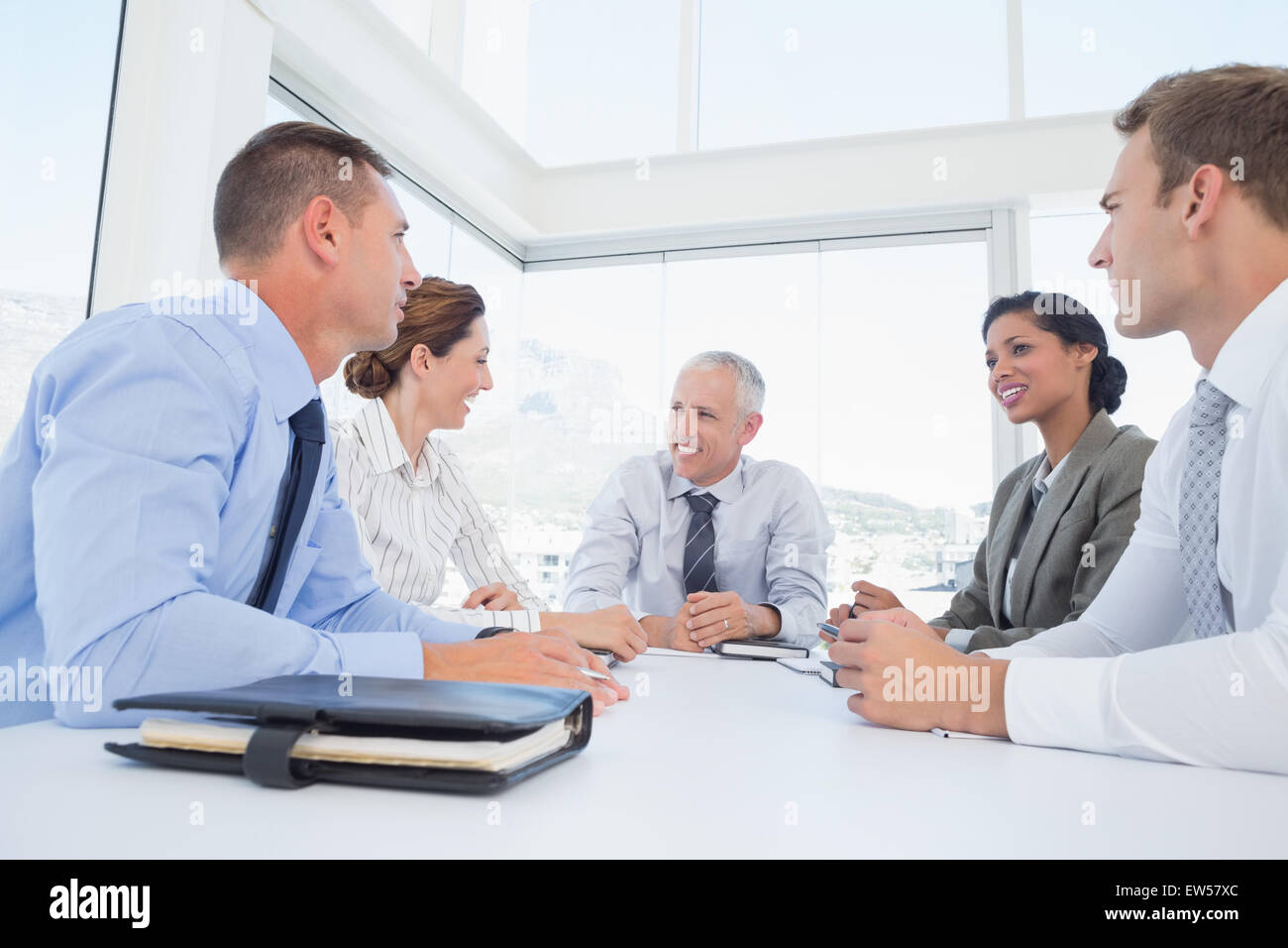 Business team sitting together around the table Stock Photo - Alamy