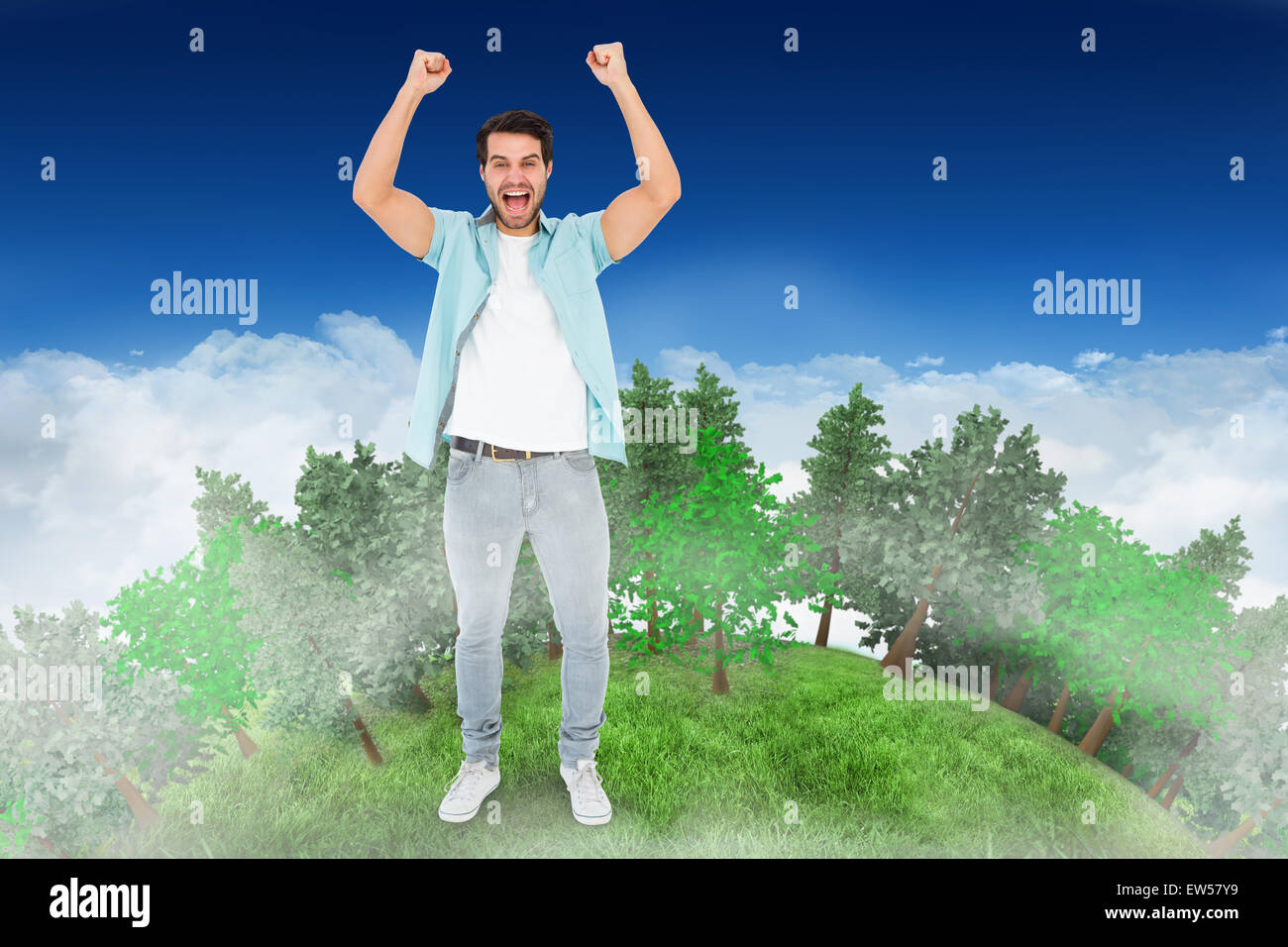 Composite image of happy casual man cheering at camera Stock Photo - Alamy