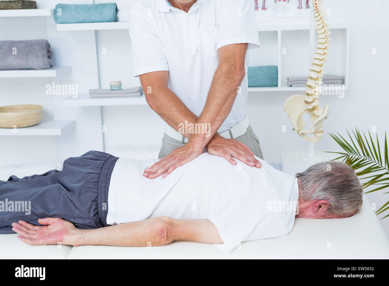 Physiotherapist doing back massage Stock Photo - Alamy