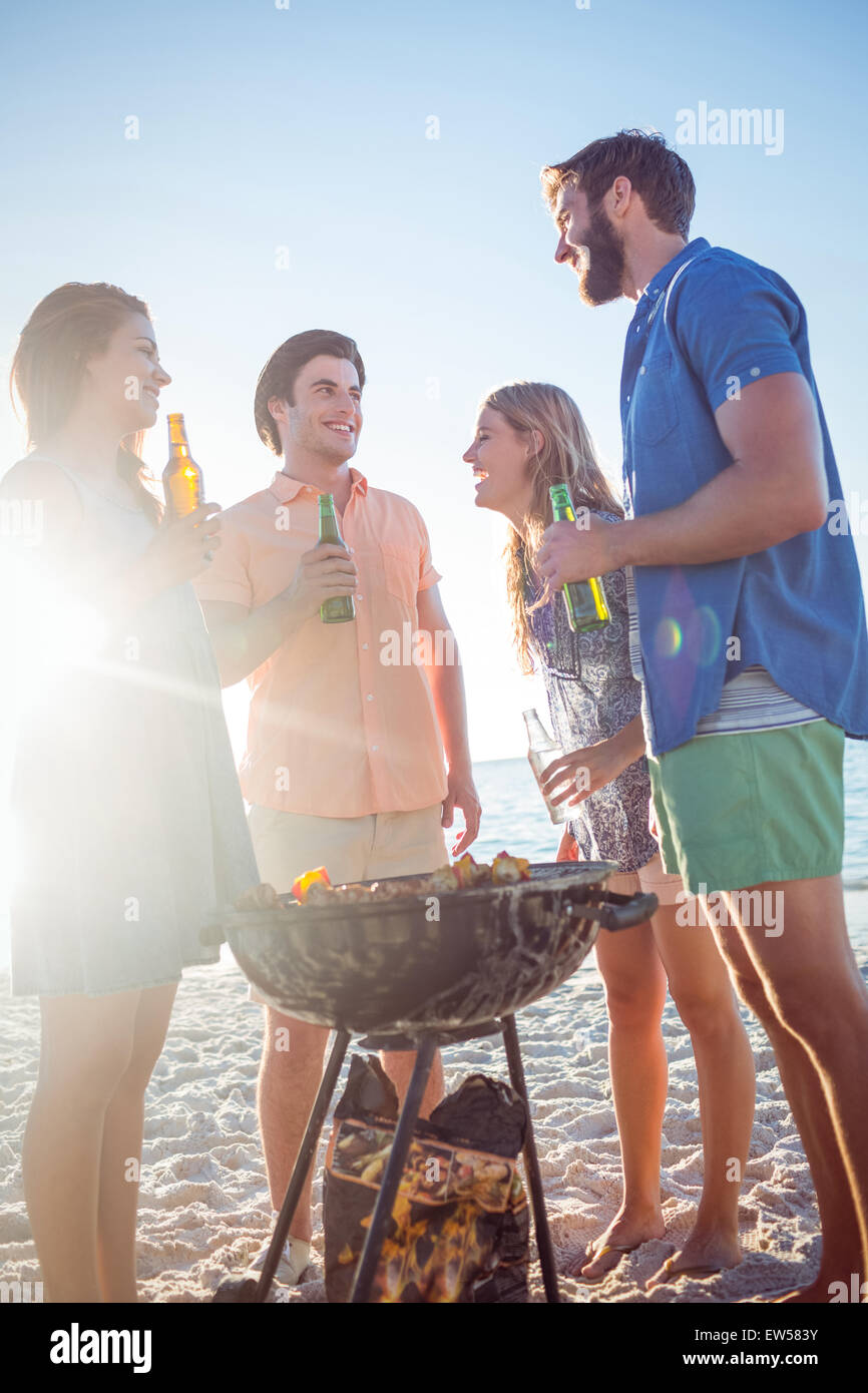 Happy friends doing barbecue and drinking beer Stock Photo - Alamy