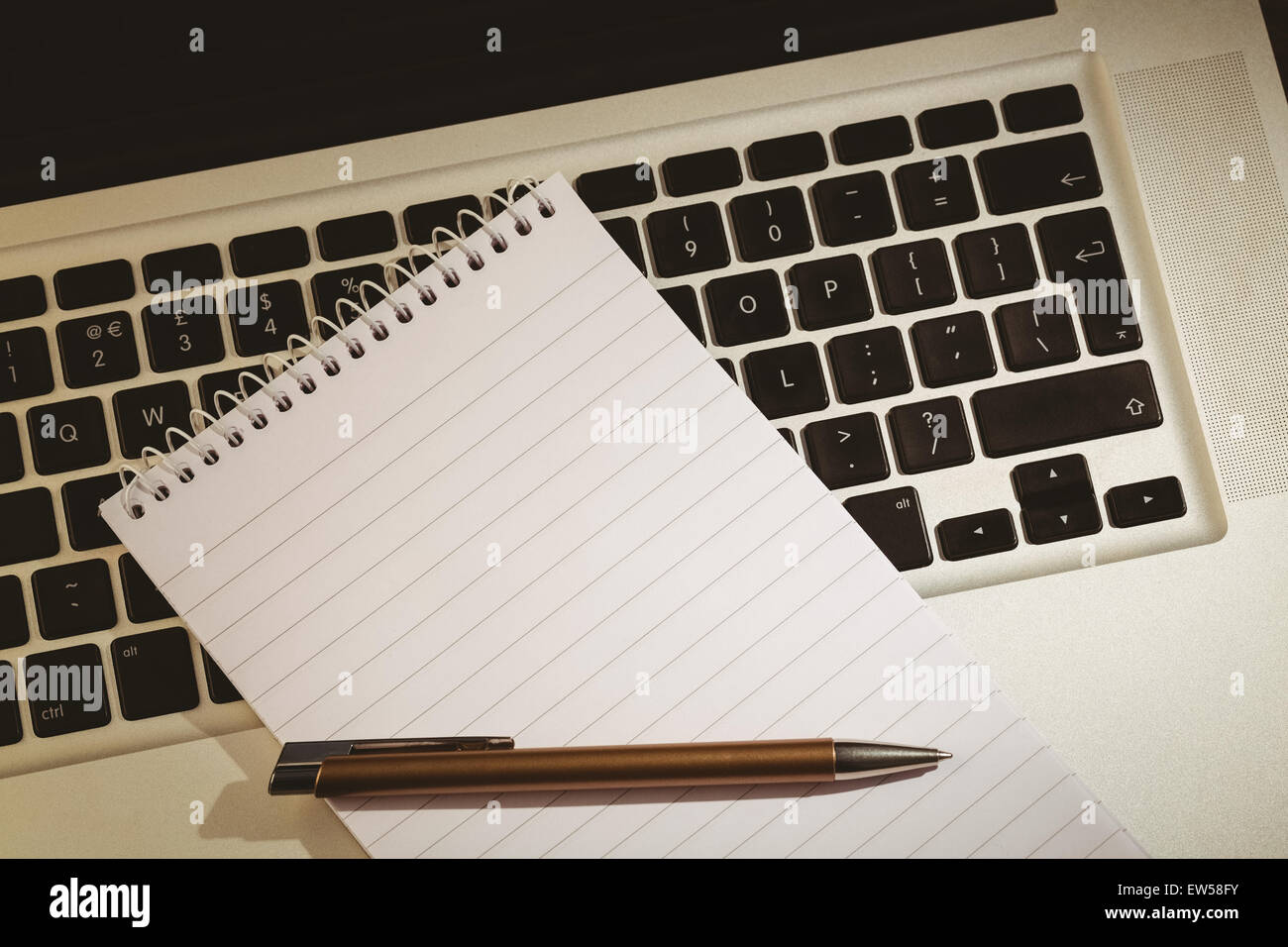 Notepad and pen on laptop Stock Photo - Alamy