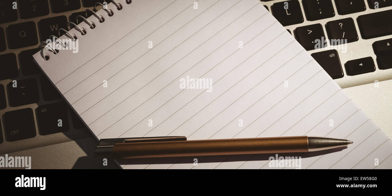 Notepad and pen on laptop Stock Photo - Alamy