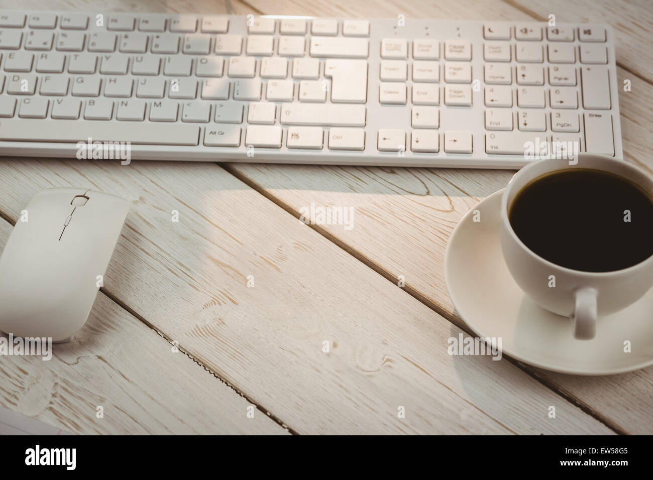 White keyboard and cup of coffee Stock Photo - Alamy