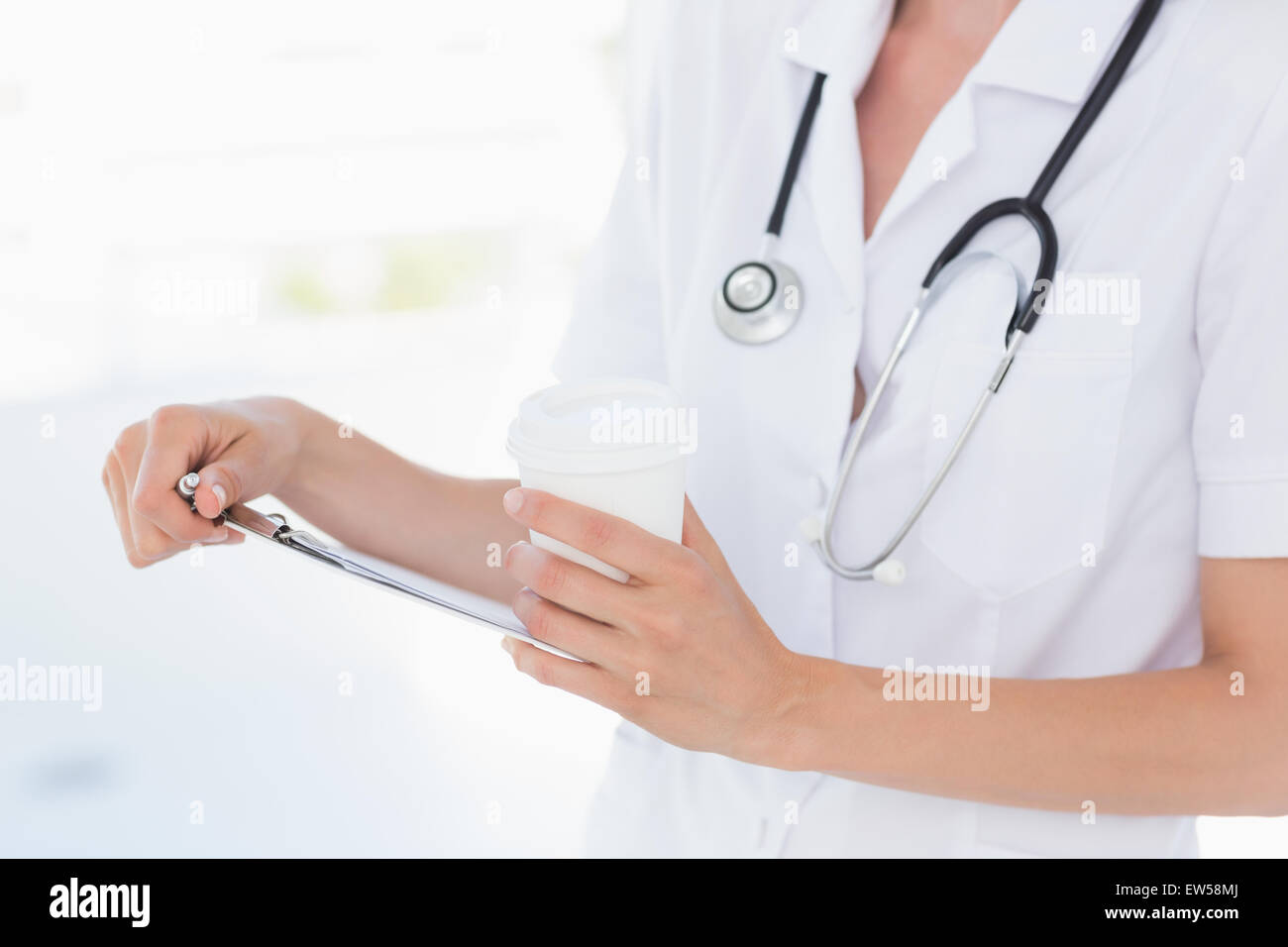 Beautiful doctor reading files Stock Photo - Alamy