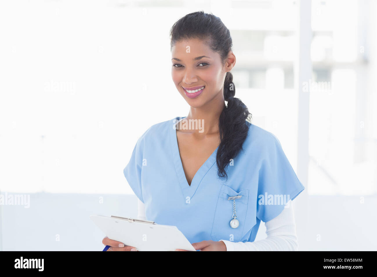 Beautiful doctor reading files Stock Photo - Alamy