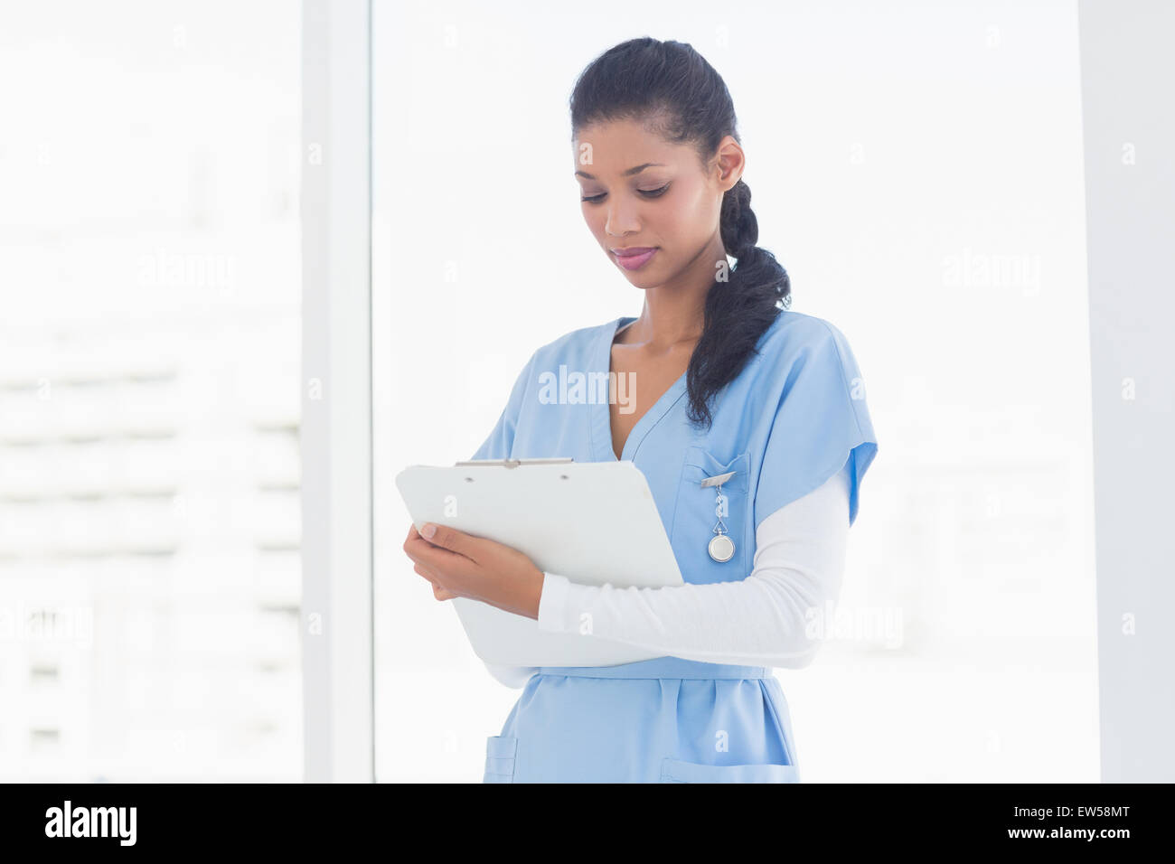 Beautiful doctor reading files Stock Photo - Alamy