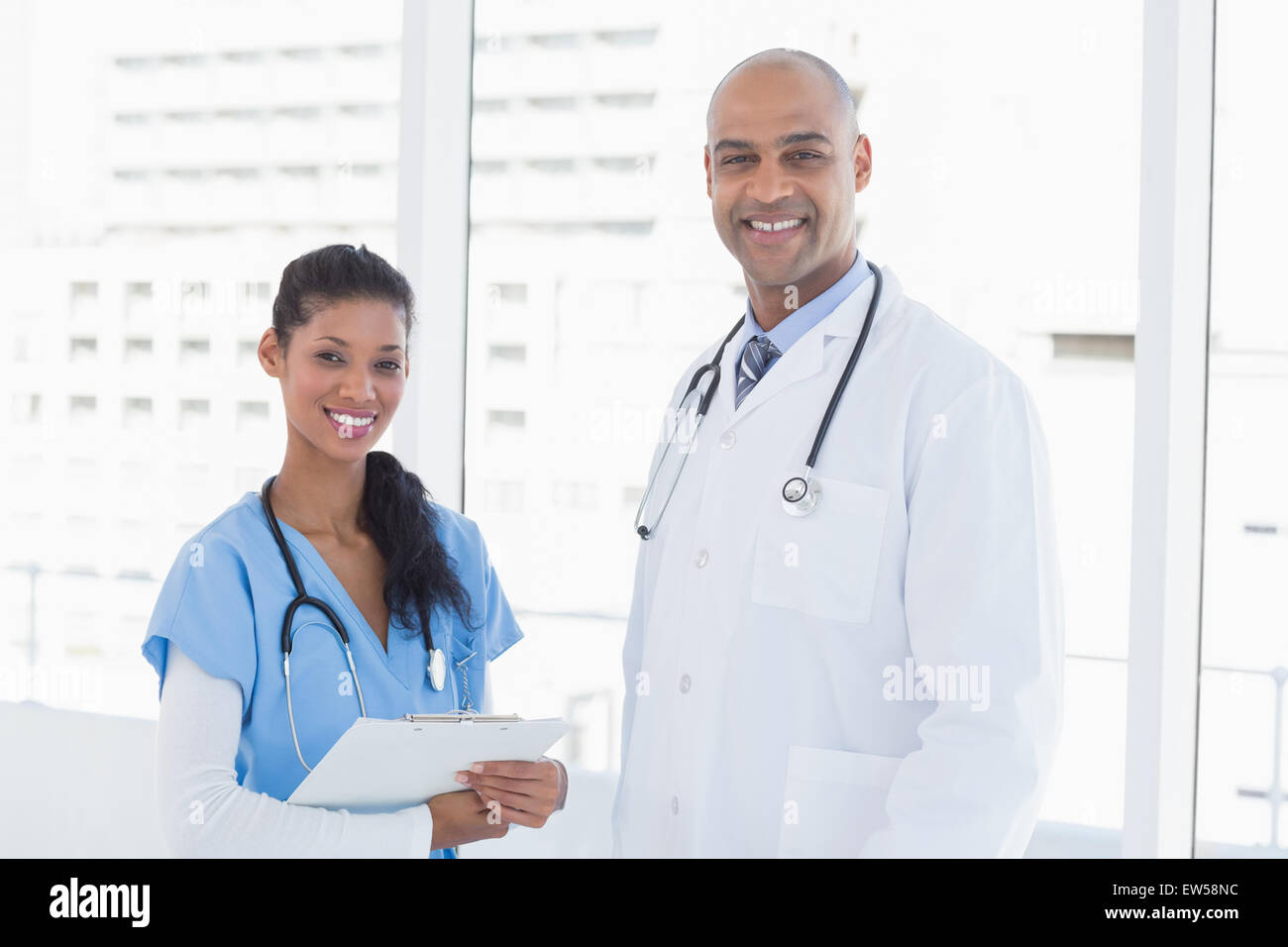 Smiling doctors looking at camera Stock Photo - Alamy
