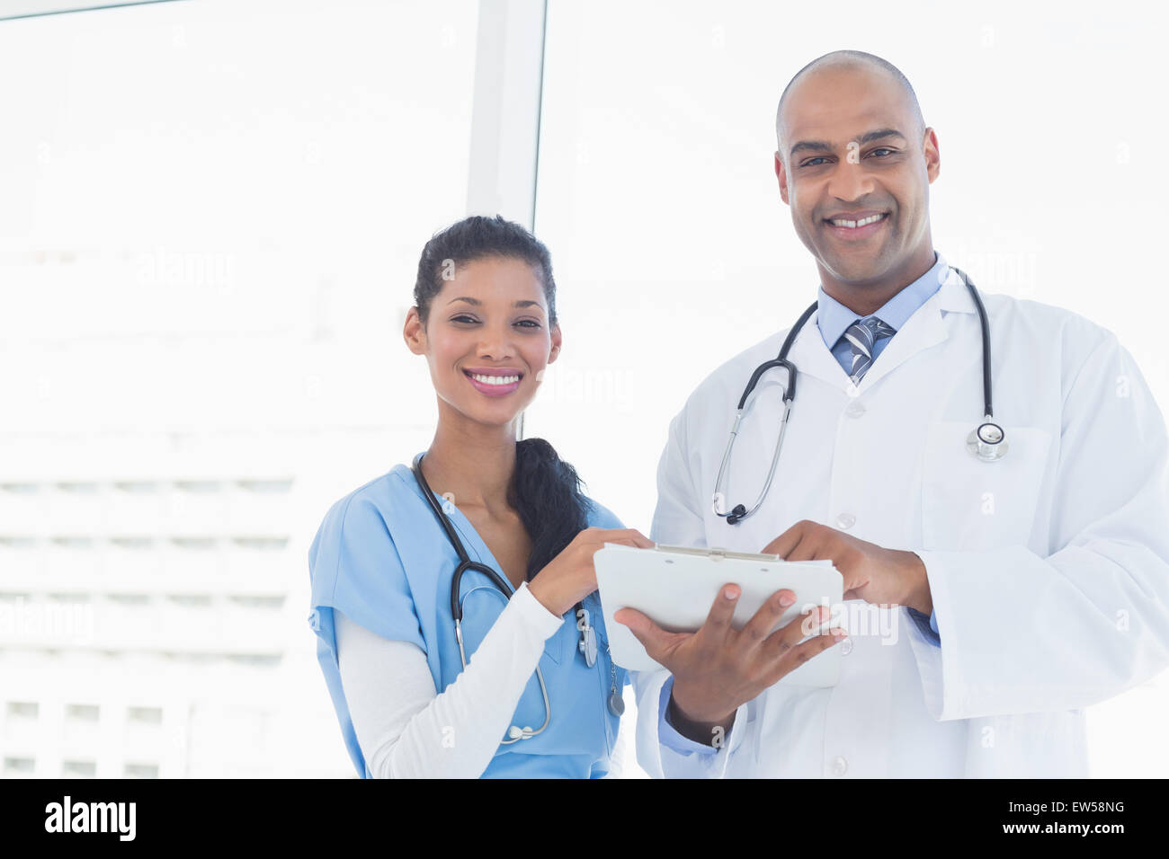 Smiling doctors looking at camera Stock Photo - Alamy
