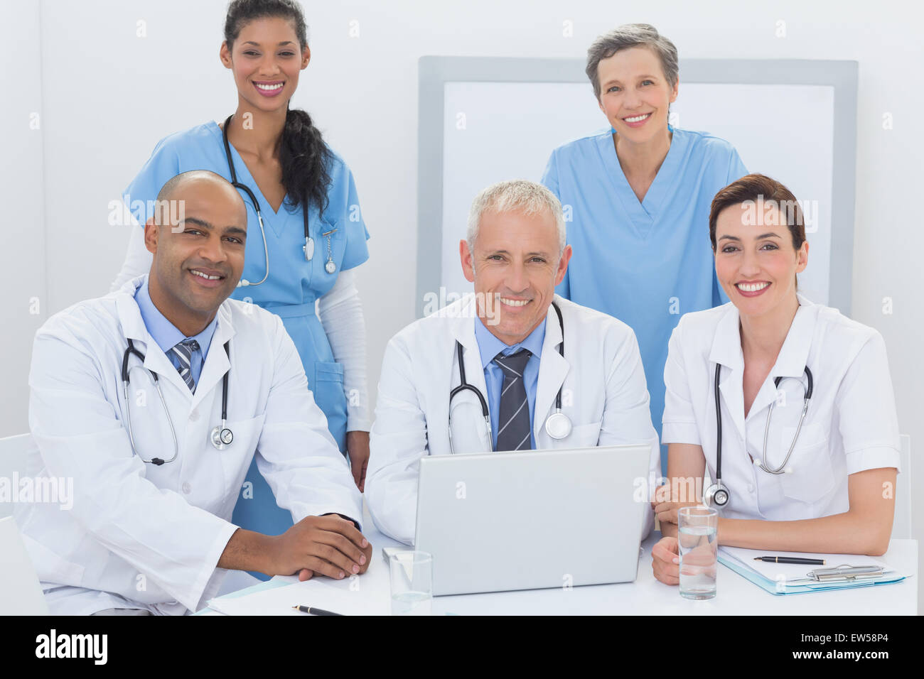 Team of doctors working on laptop Stock Photo - Alamy