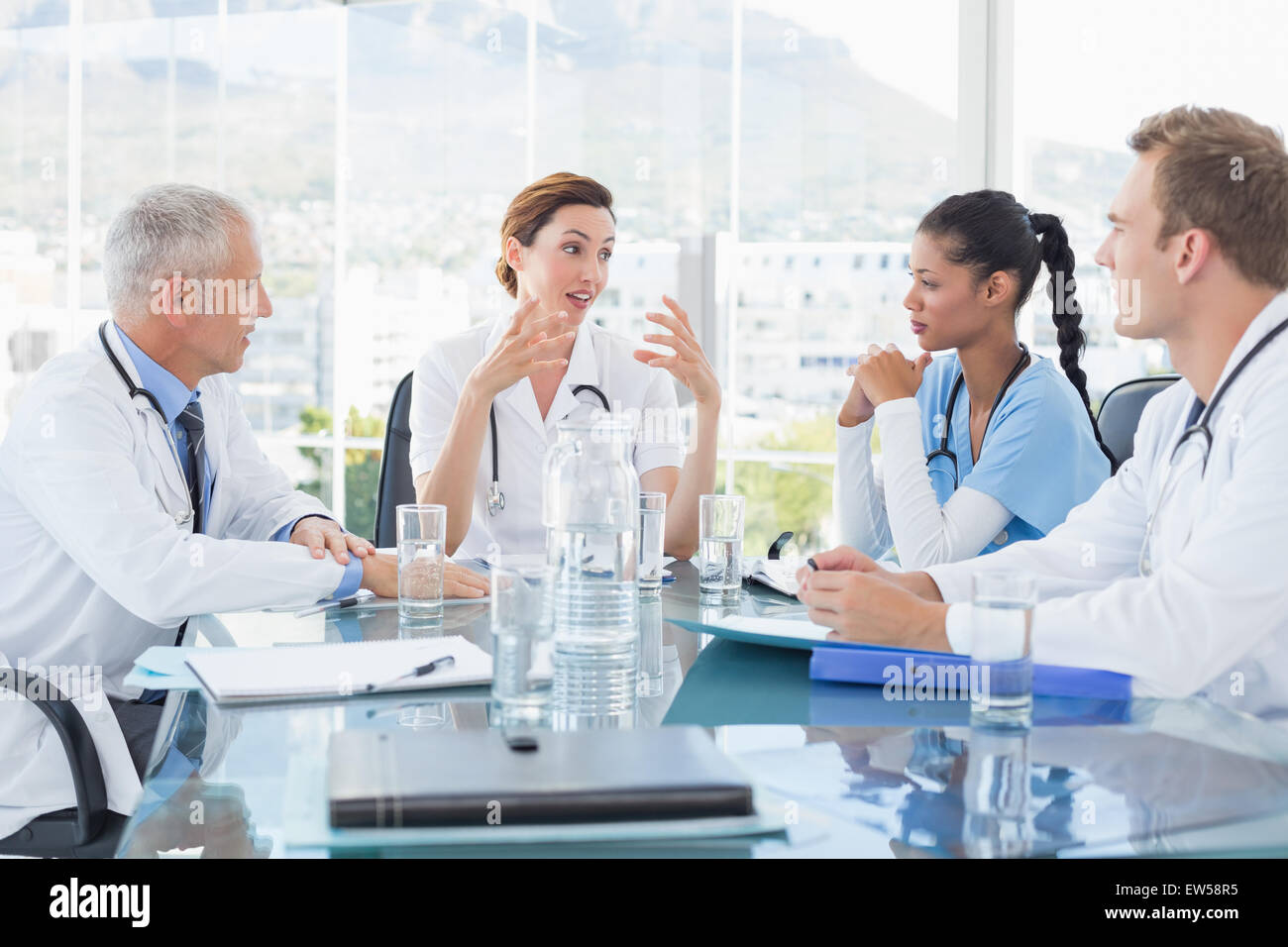 Team of smiling doctors having a meeting Stock Photo - Alamy