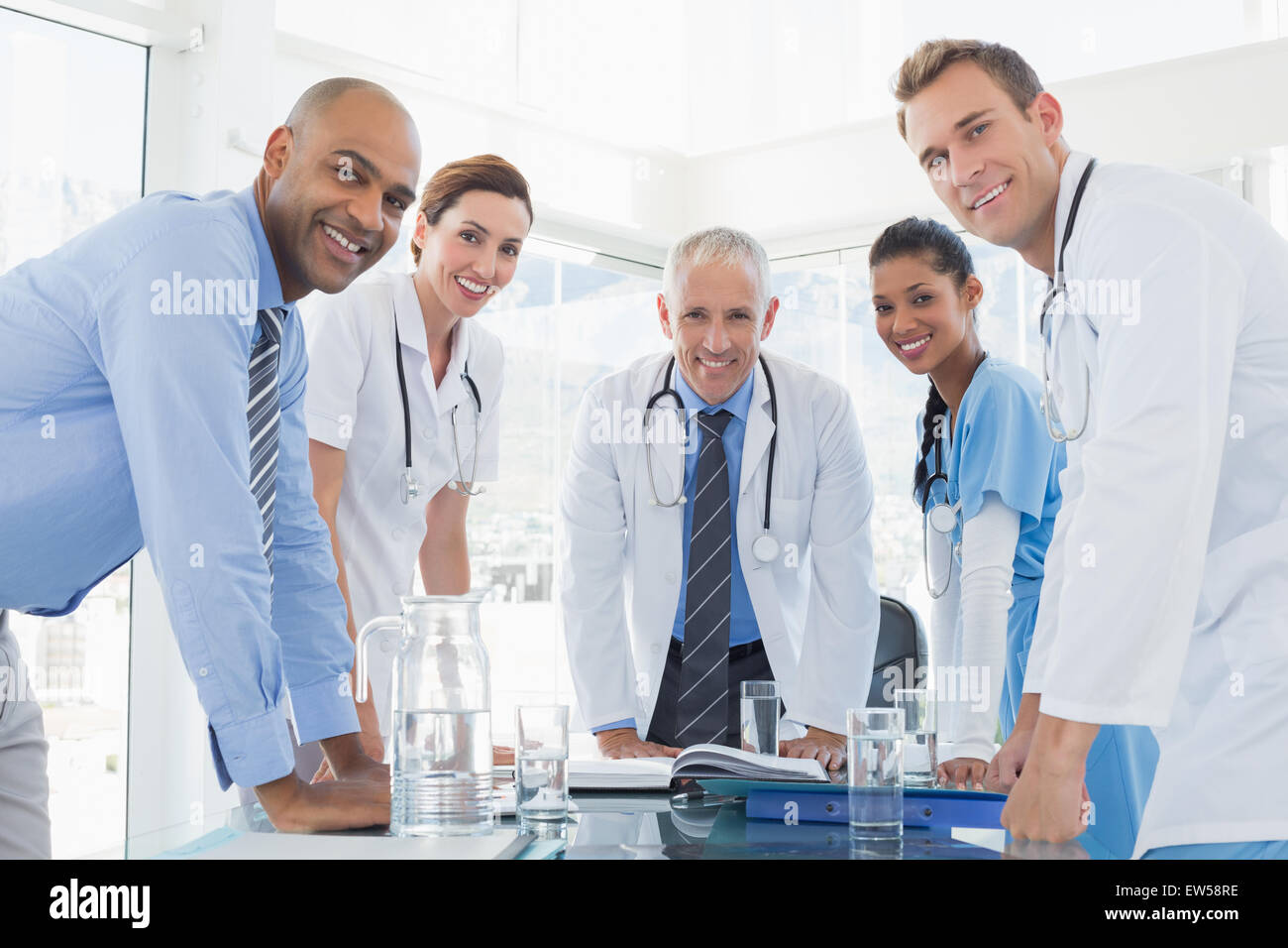 Team of smiling doctors having a meeting Stock Photo - Alamy