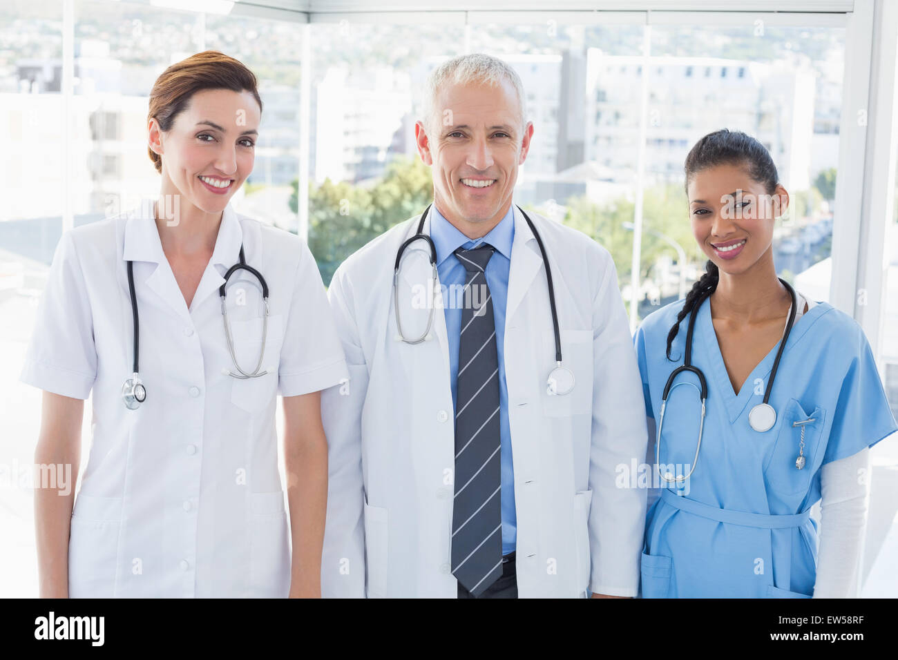 Smiling doctors looking at camera Stock Photo - Alamy