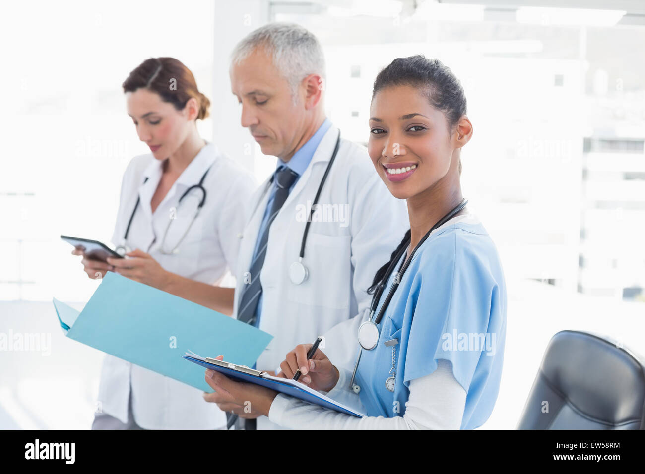 Doctors working together on patients file Stock Photo - Alamy