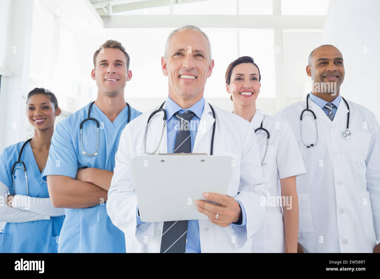 Medical team looking camera arms hi-res stock photography and images ...