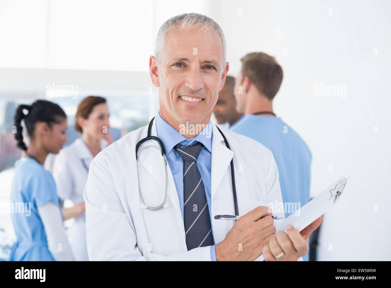 Smiling professional male doctor hi-res stock photography and images ...