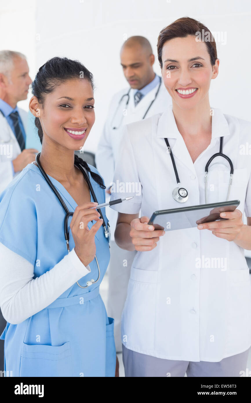 Beautiful female doctors working together with tablet Stock Photo - Alamy