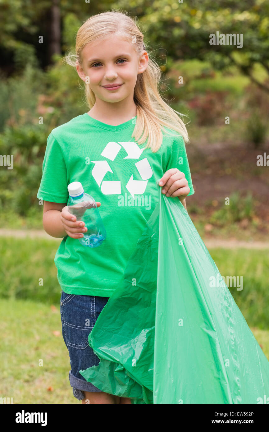 Happy little girl collecting rubbish Stock Photo - Alamy