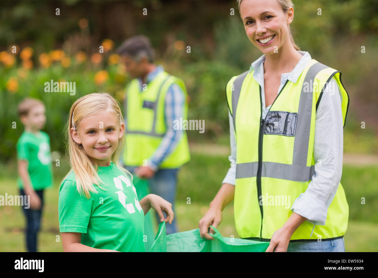 Happy family collecting rubbish Stock Photo - Alamy