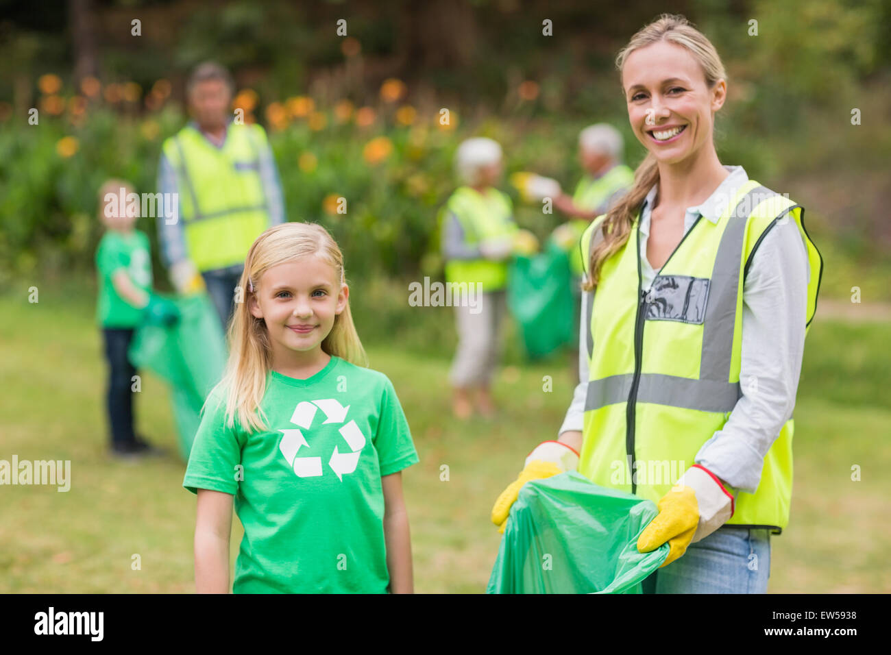 Happy family collecting rubbish Stock Photo - Alamy