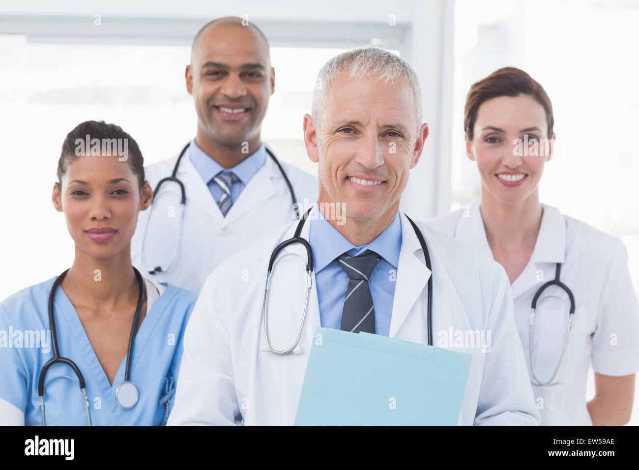 Team of smiling doctors looking at camera Stock Photo - Alamy