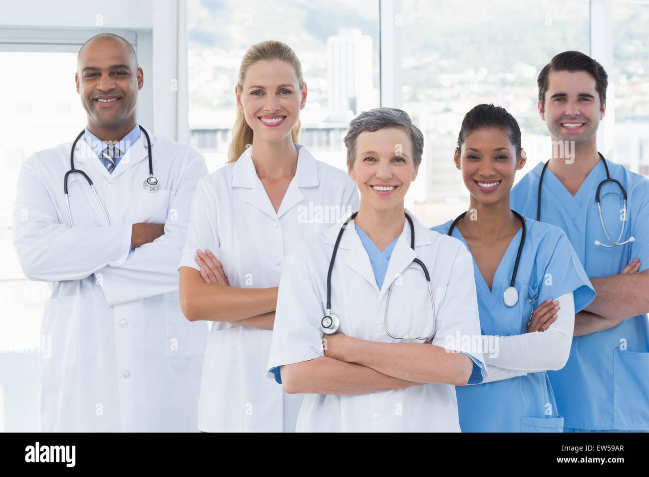 Team of smiling doctors looking at camera Stock Photo - Alamy