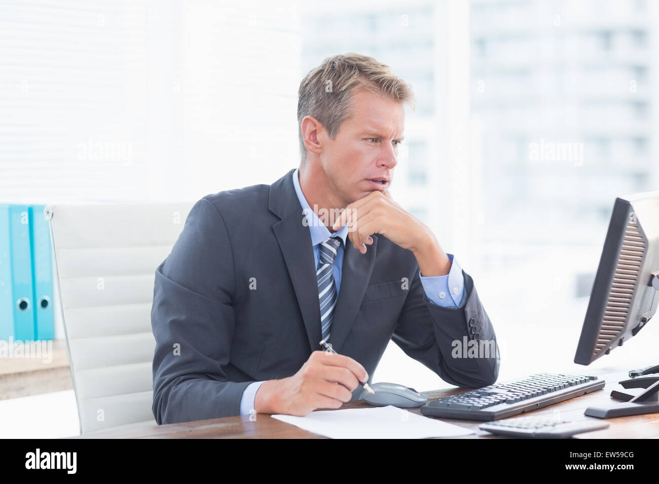 Serious businessman on his pc Stock Photo - Alamy