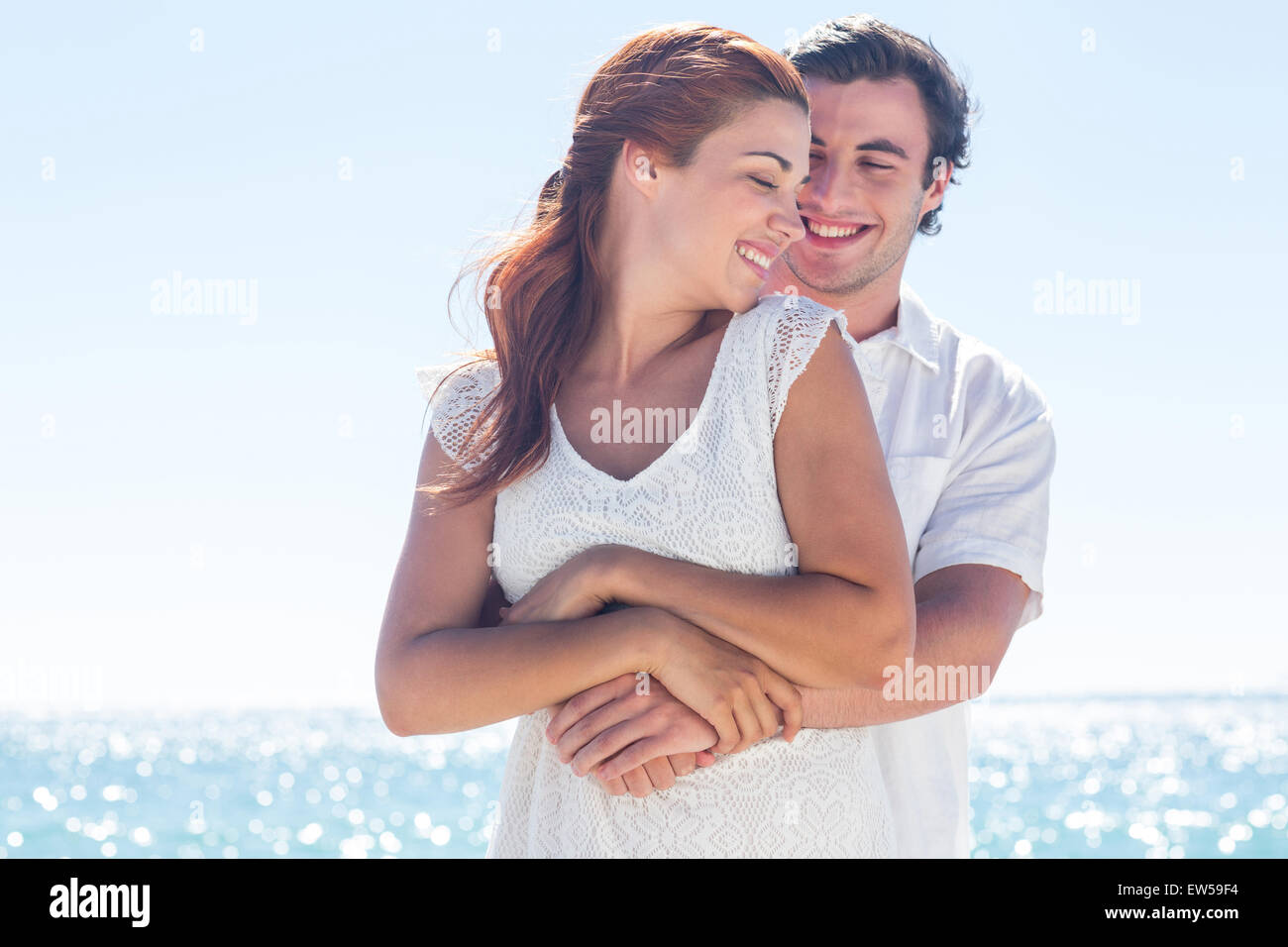 Happy couple hugging and looking at each other Stock Photo - Alamy