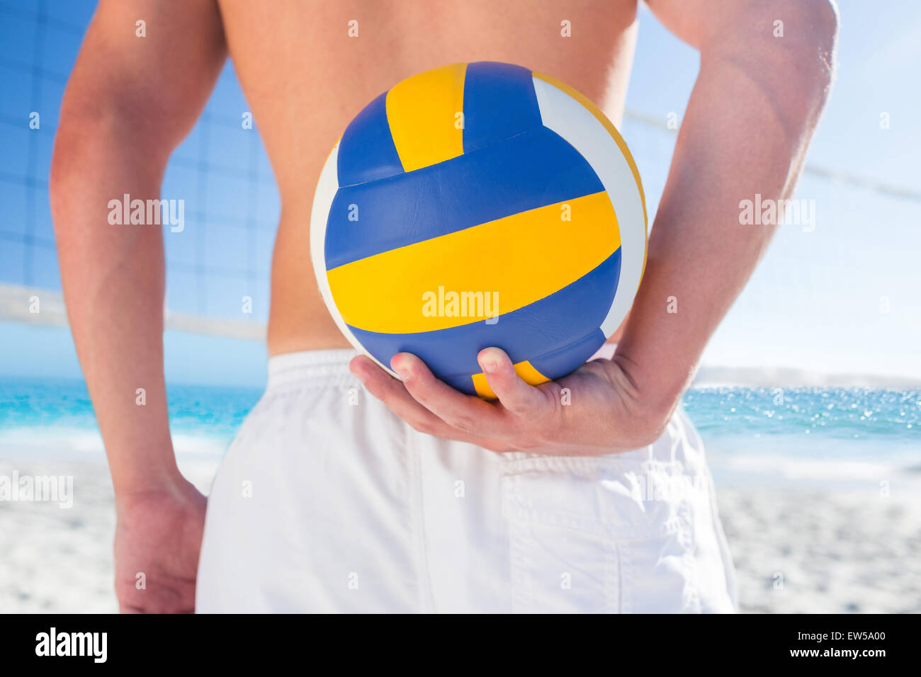 Handsome man holding volleyball Stock Photo - Alamy