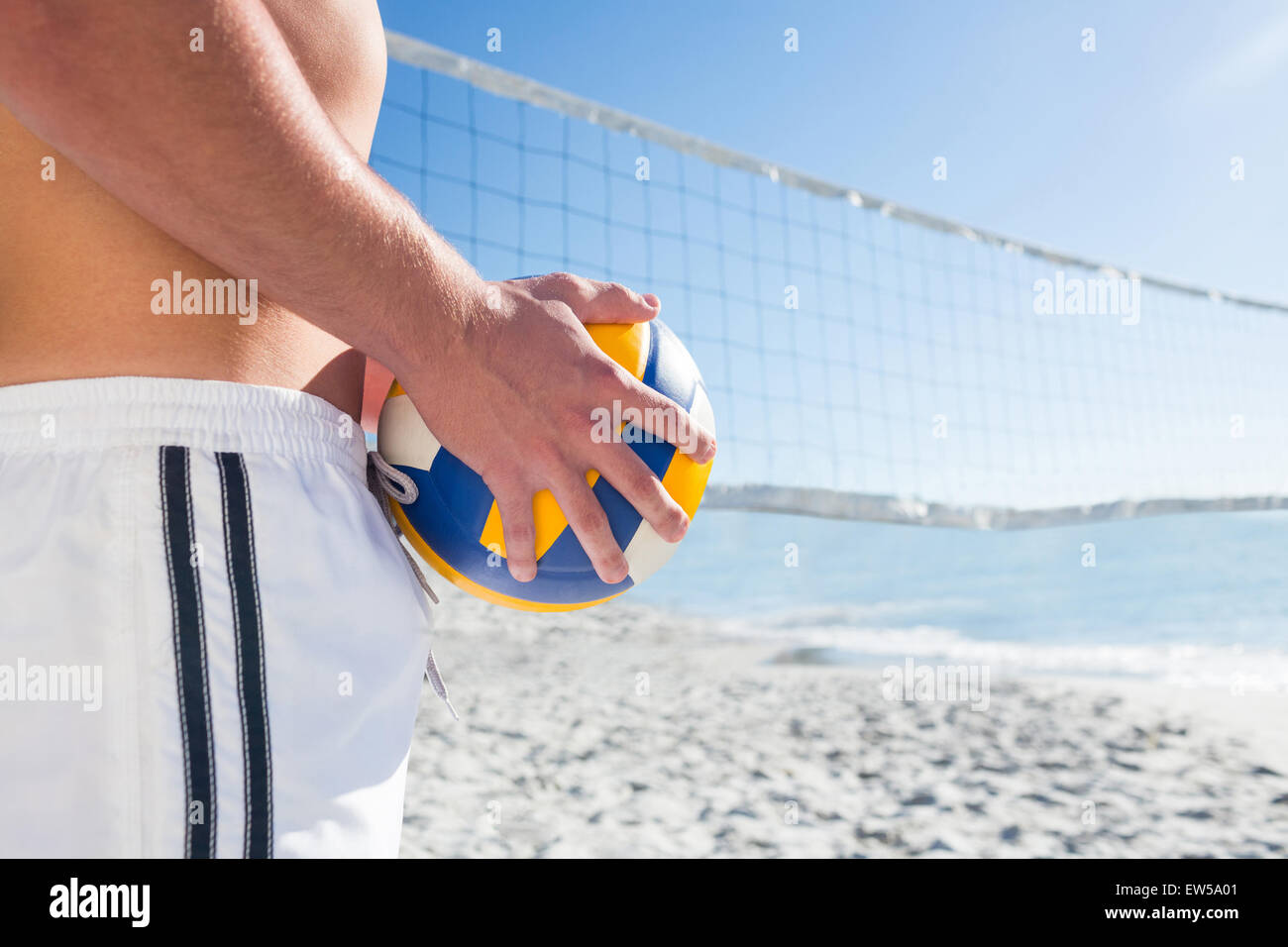 Handsome man holding volleyball Stock Photo - Alamy