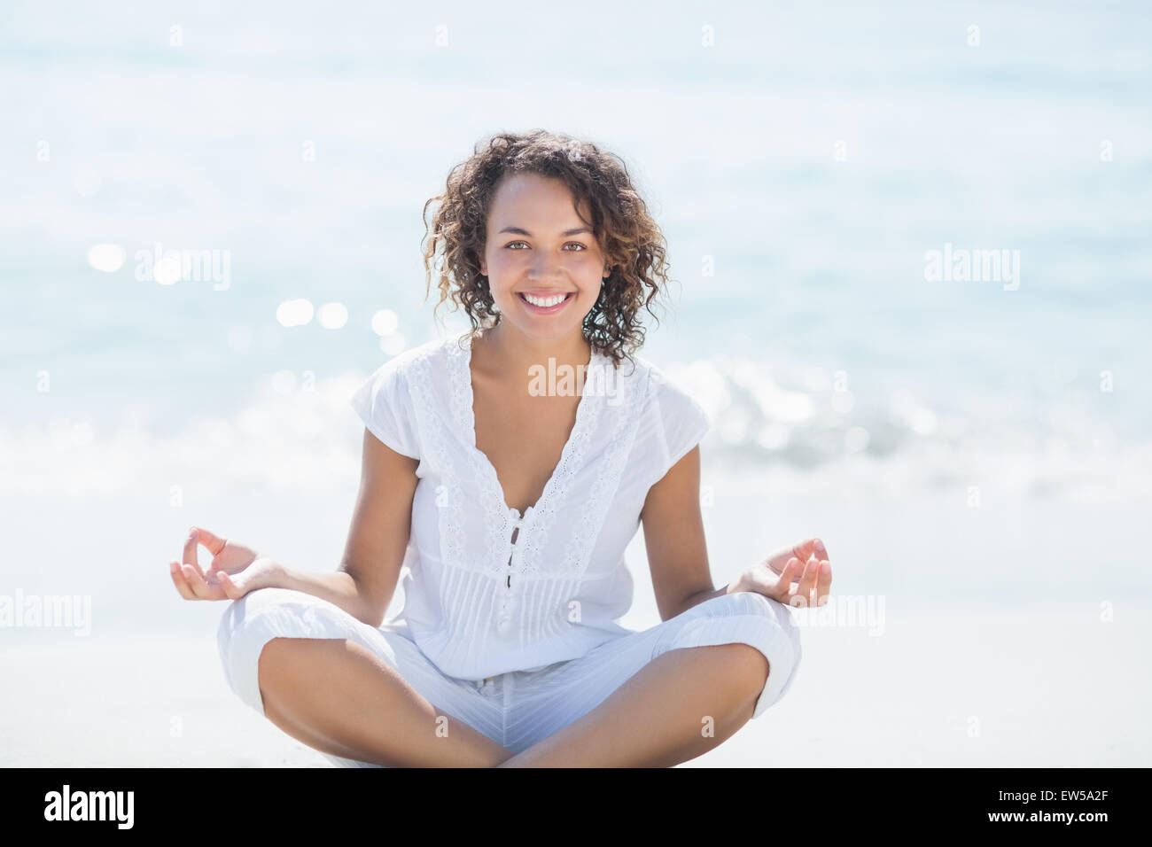 happy woman doing yoga beside the sea Stock Photo - Alamy