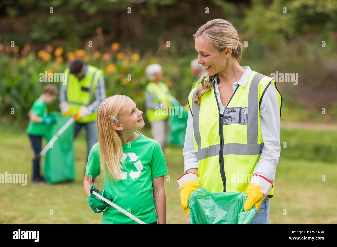 Happy family collecting rubbish Stock Photo - Alamy