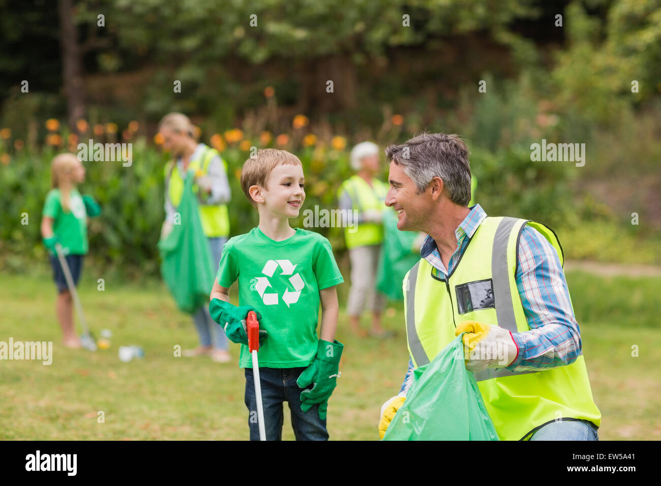 Happy family collecting rubbish Stock Photo - Alamy