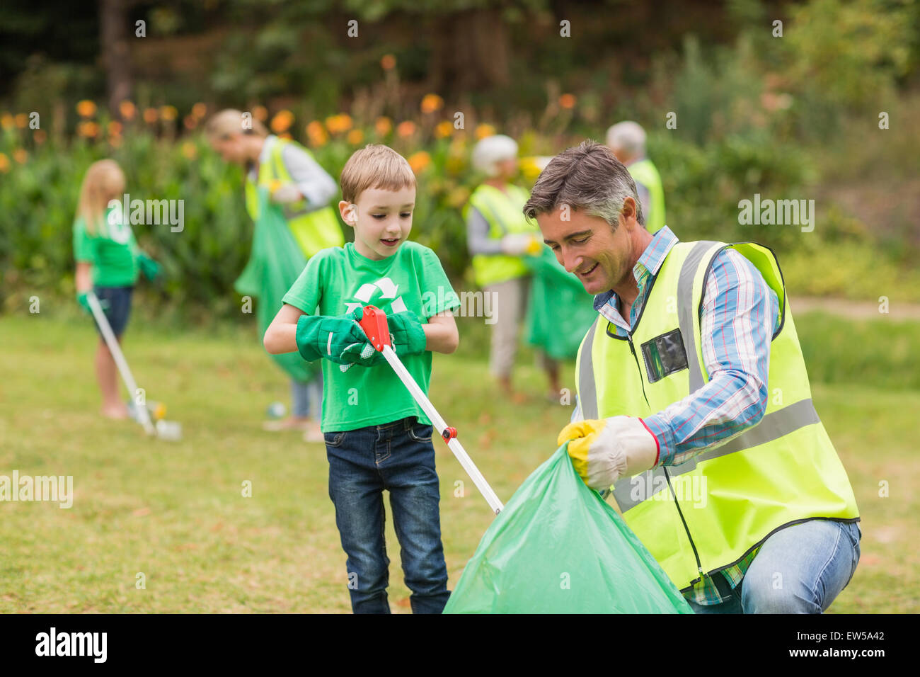 Happy family collecting rubbish Stock Photo - Alamy