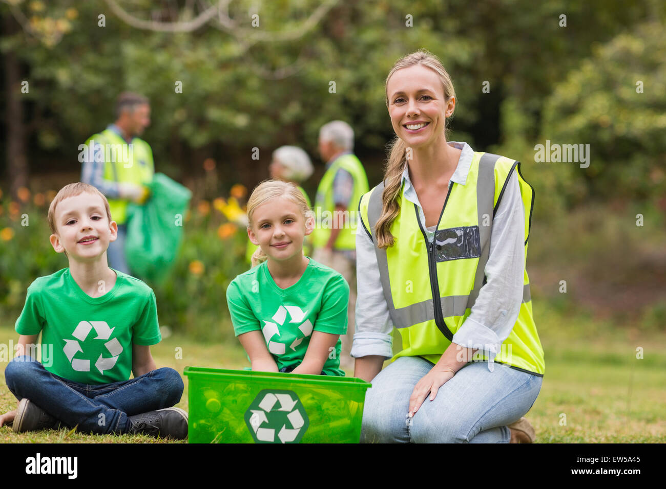 Happy family collecting rubbish Stock Photo - Alamy
