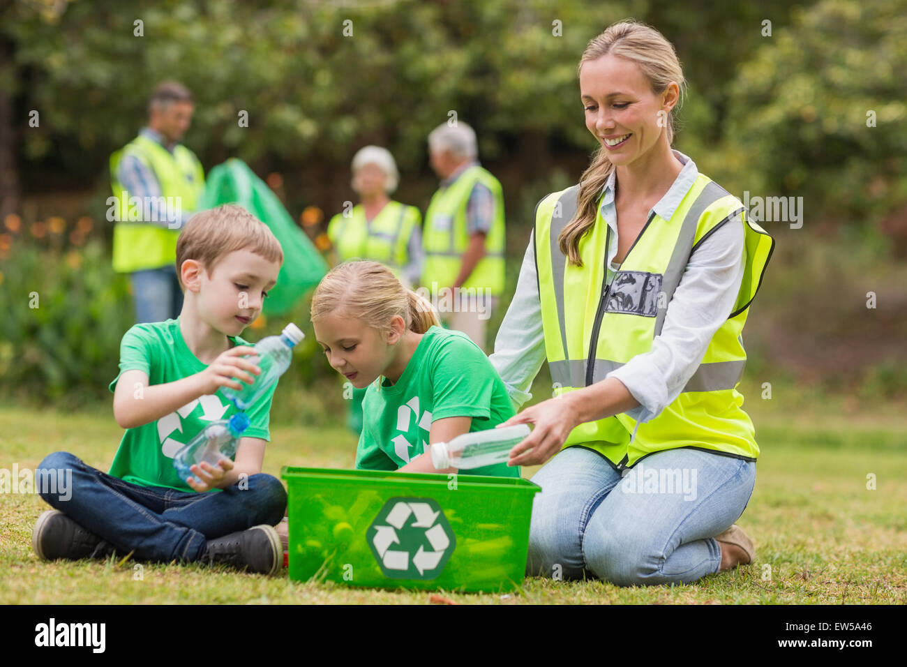 Happy family collecting rubbish Stock Photo - Alamy