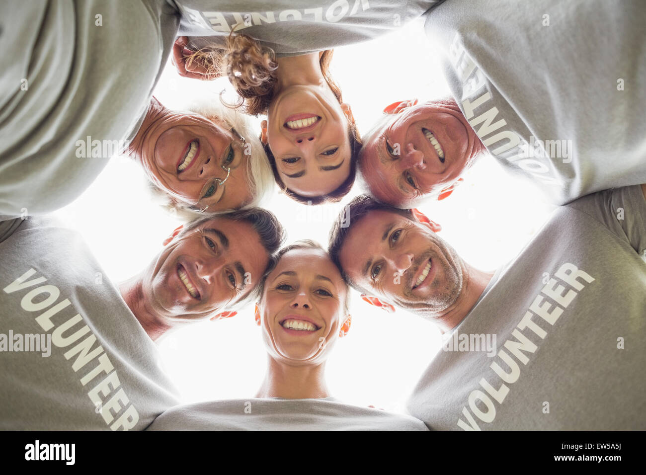 Happy volunteer family looking down at the camera Stock Photo - Alamy