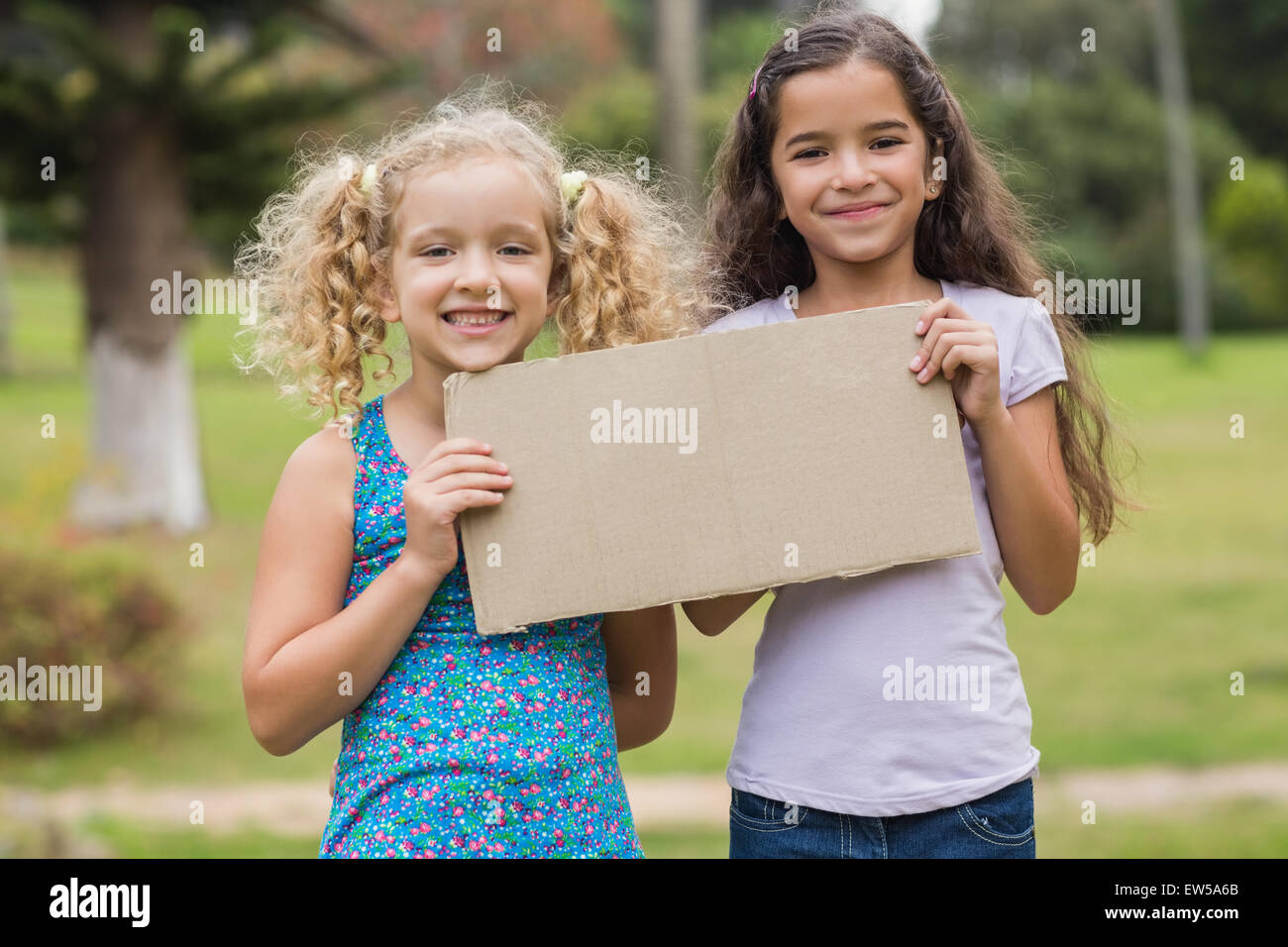 Happy children holding blank Stock Photo - Alamy