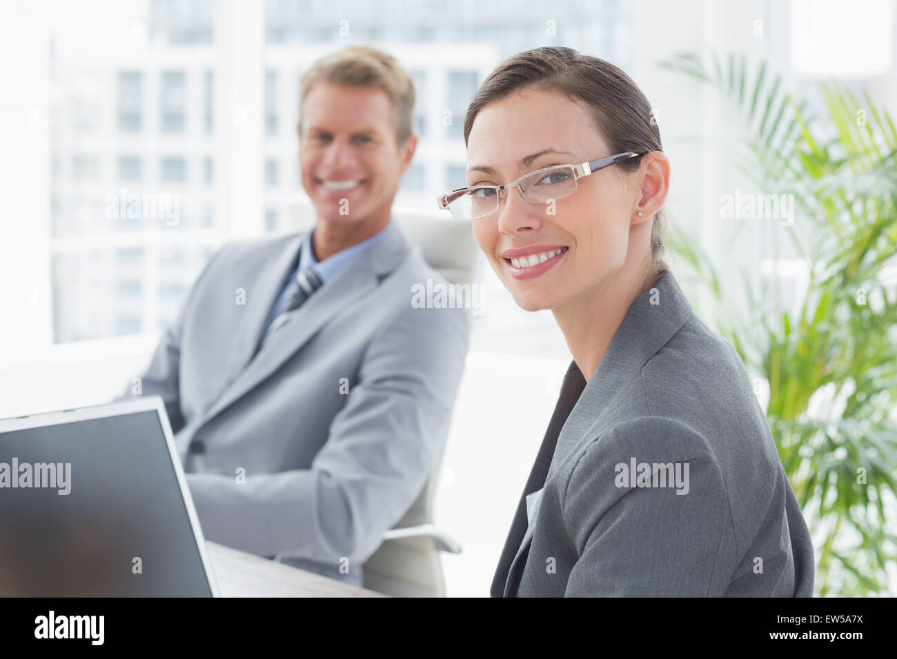 Smiling business partners working together Stock Photo - Alamy