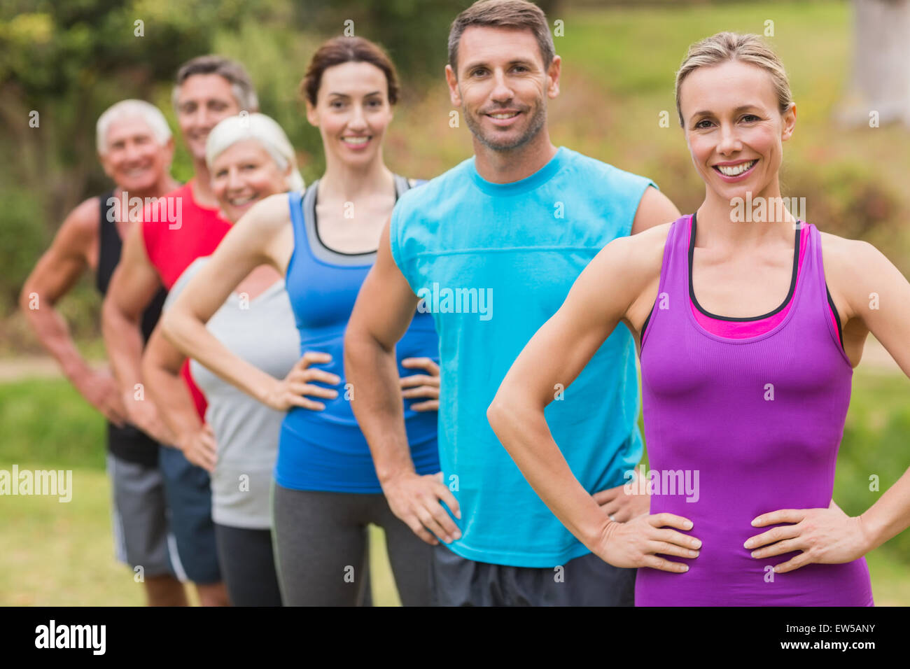 Happy athletic group smiling at camera Stock Photo - Alamy