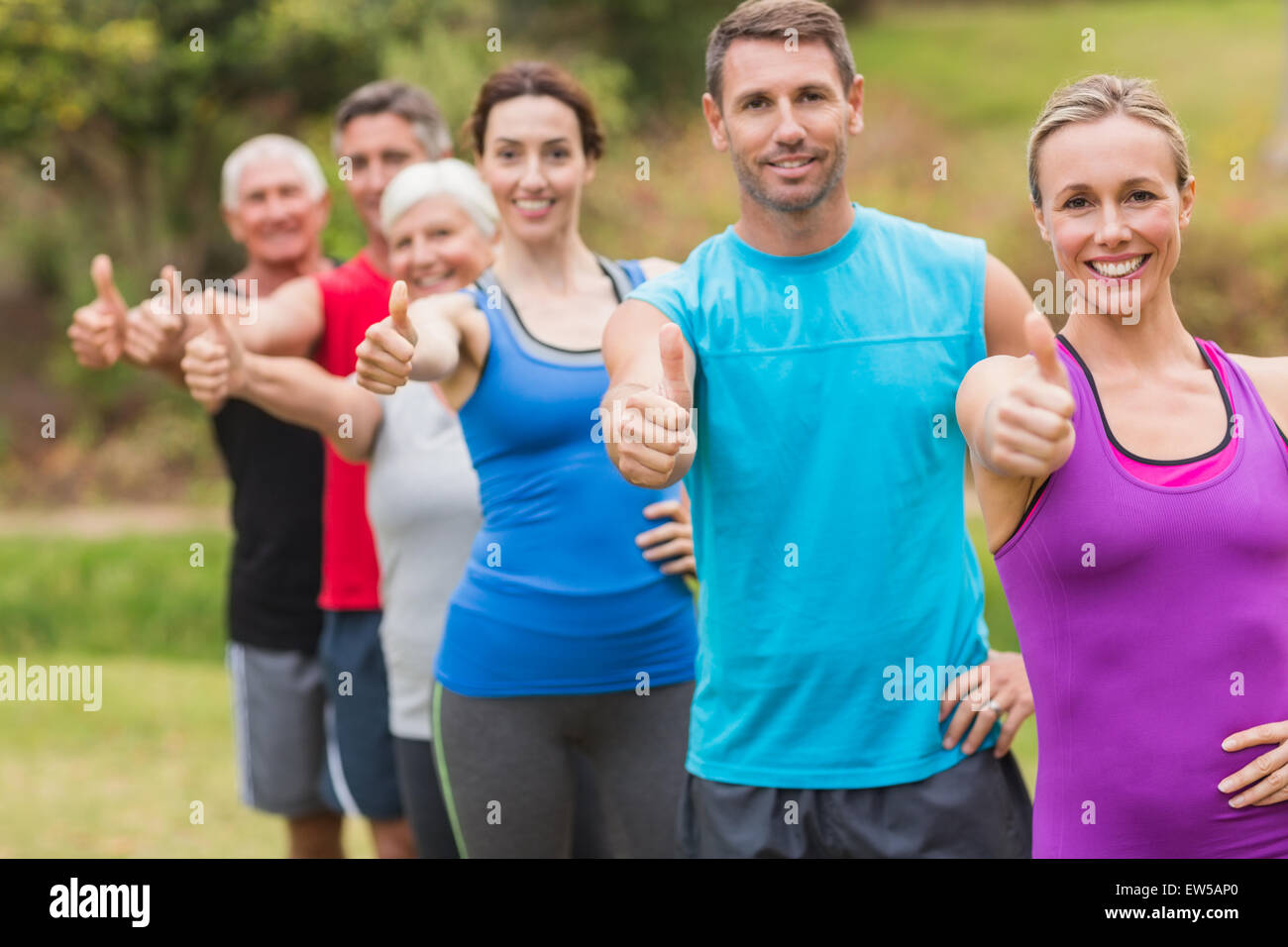 Happy athletic group with thumbs up Stock Photo - Alamy