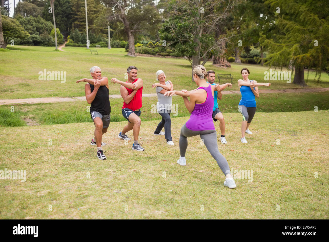 Happy athletic group training Stock Photo - Alamy