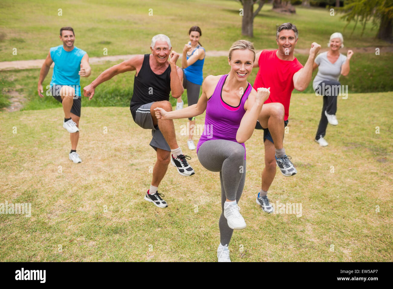 Happy athletic group training Stock Photo - Alamy