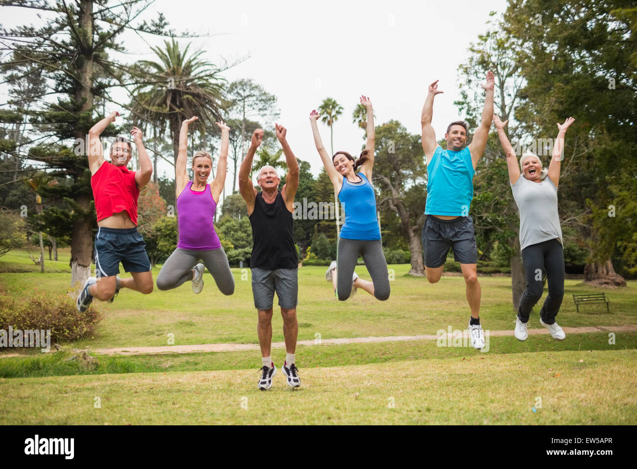 Happy athletic jumping together Stock Photo - Alamy