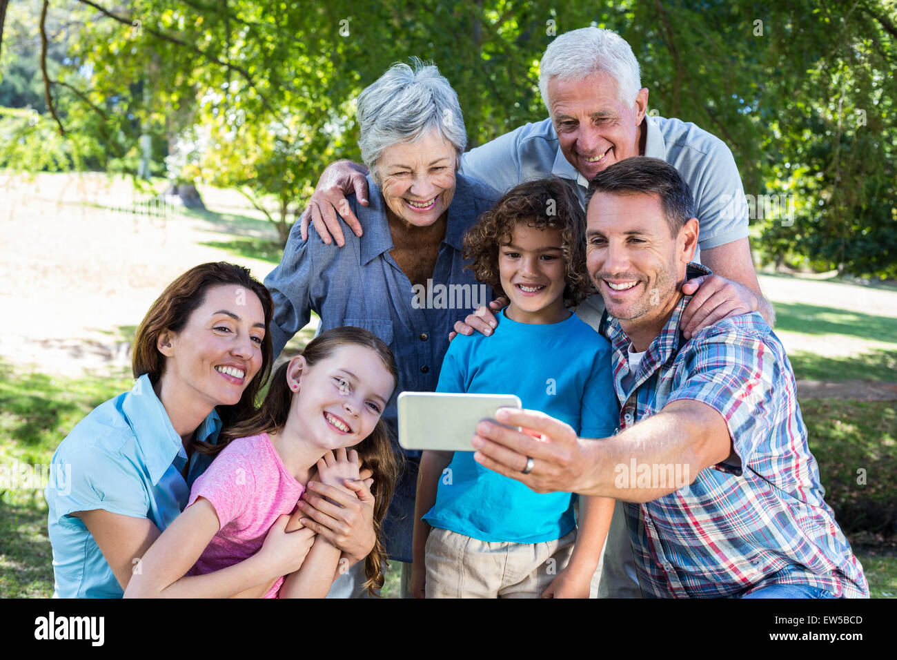 Extended family taking a selfie in the park Stock Photo - Alamy