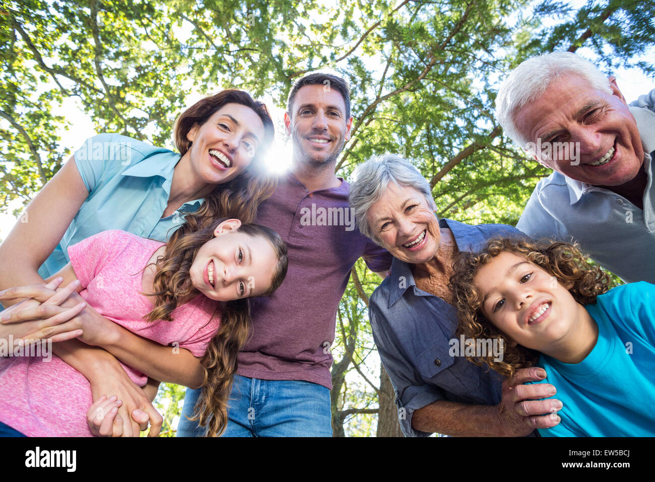 Extended family smiling in the park Stock Photo - Alamy