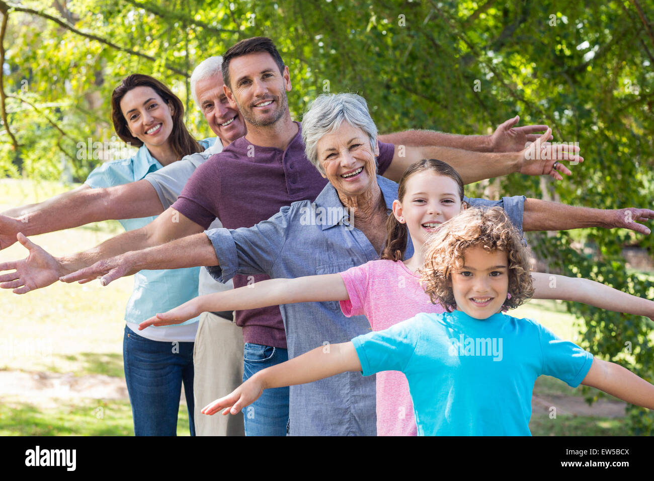 Extended family smiling in the park Stock Photo - Alamy