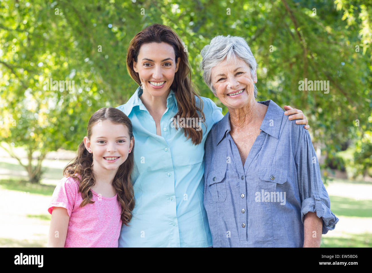 Extended family smiling in the park Stock Photo - Alamy